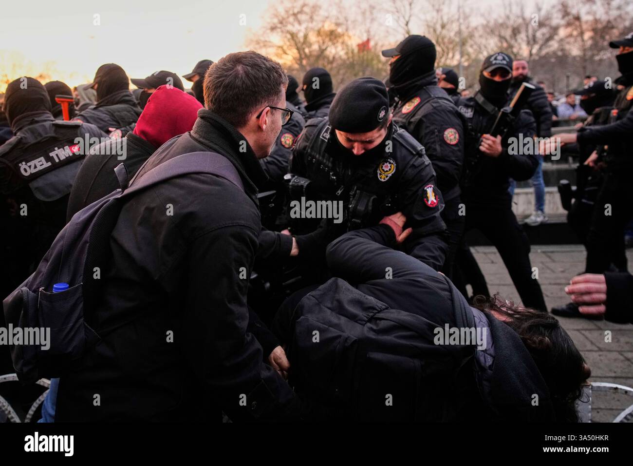 Police officers scuffle with people as they protest the arrest of ...