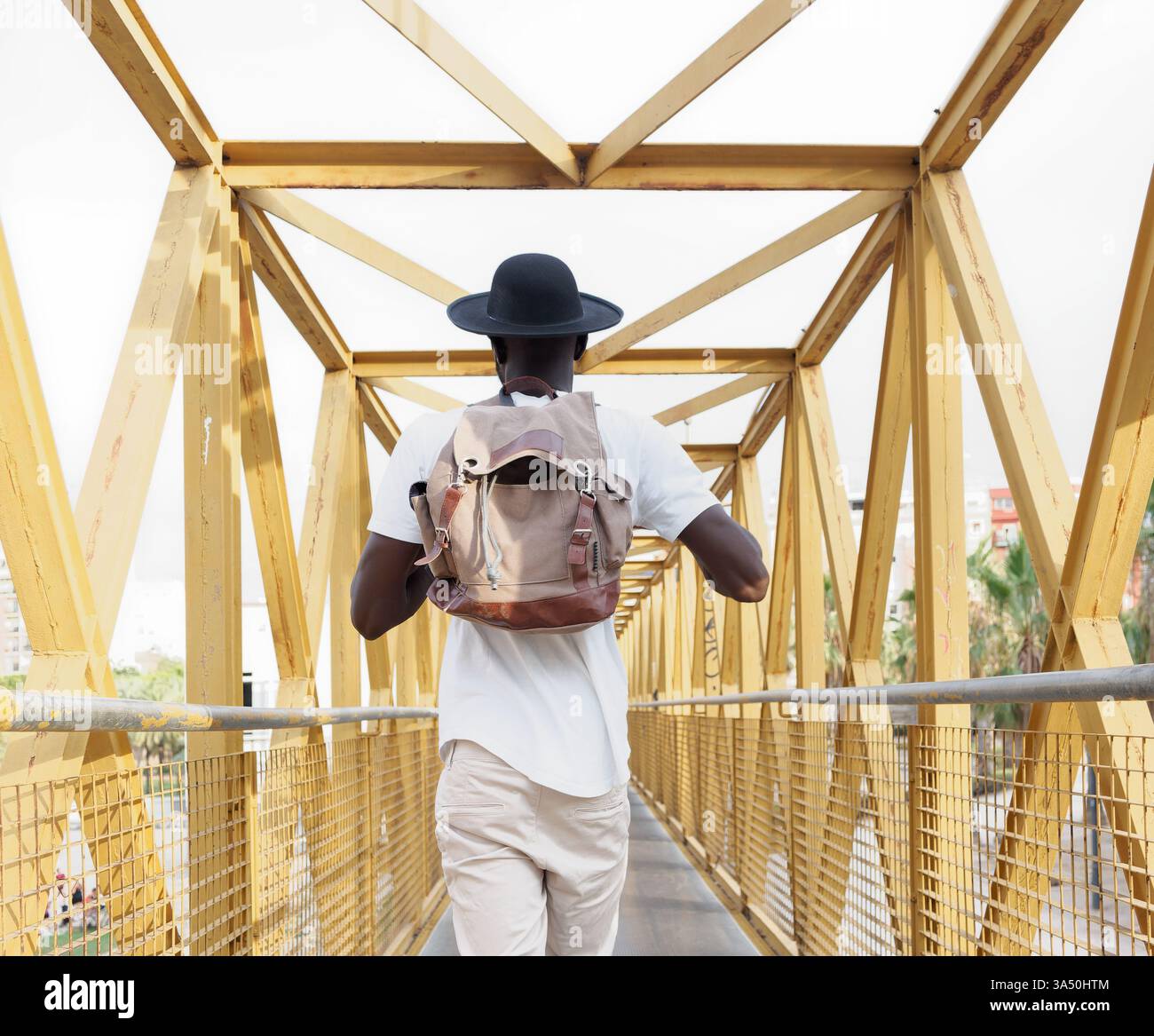 Back view of anonymous young African American male traveler in stylish ...