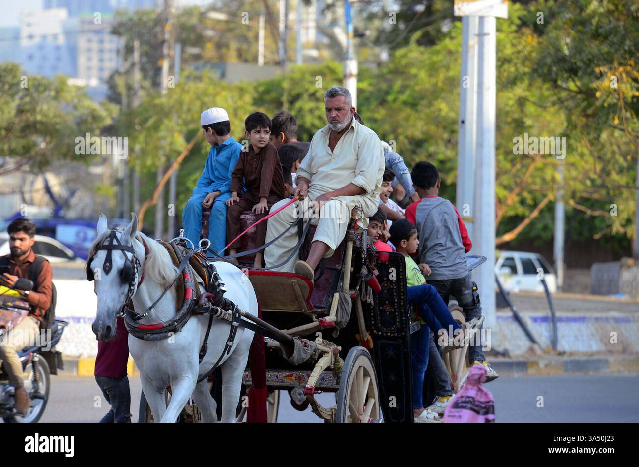 Children are enjoying horse riding at a street during Holy Month of ...