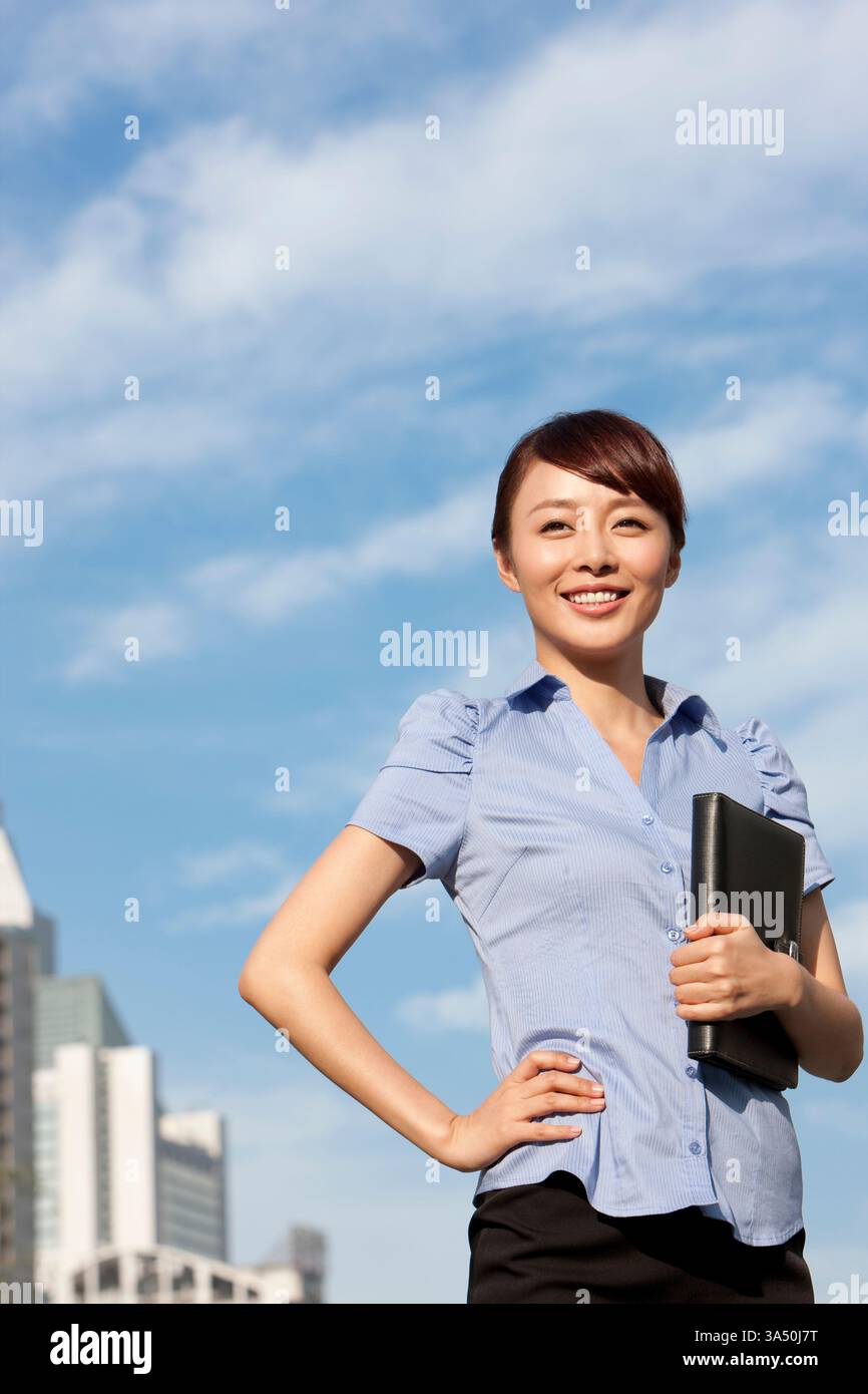Confident chinese businesswoman stands hi-res stock photography and ...