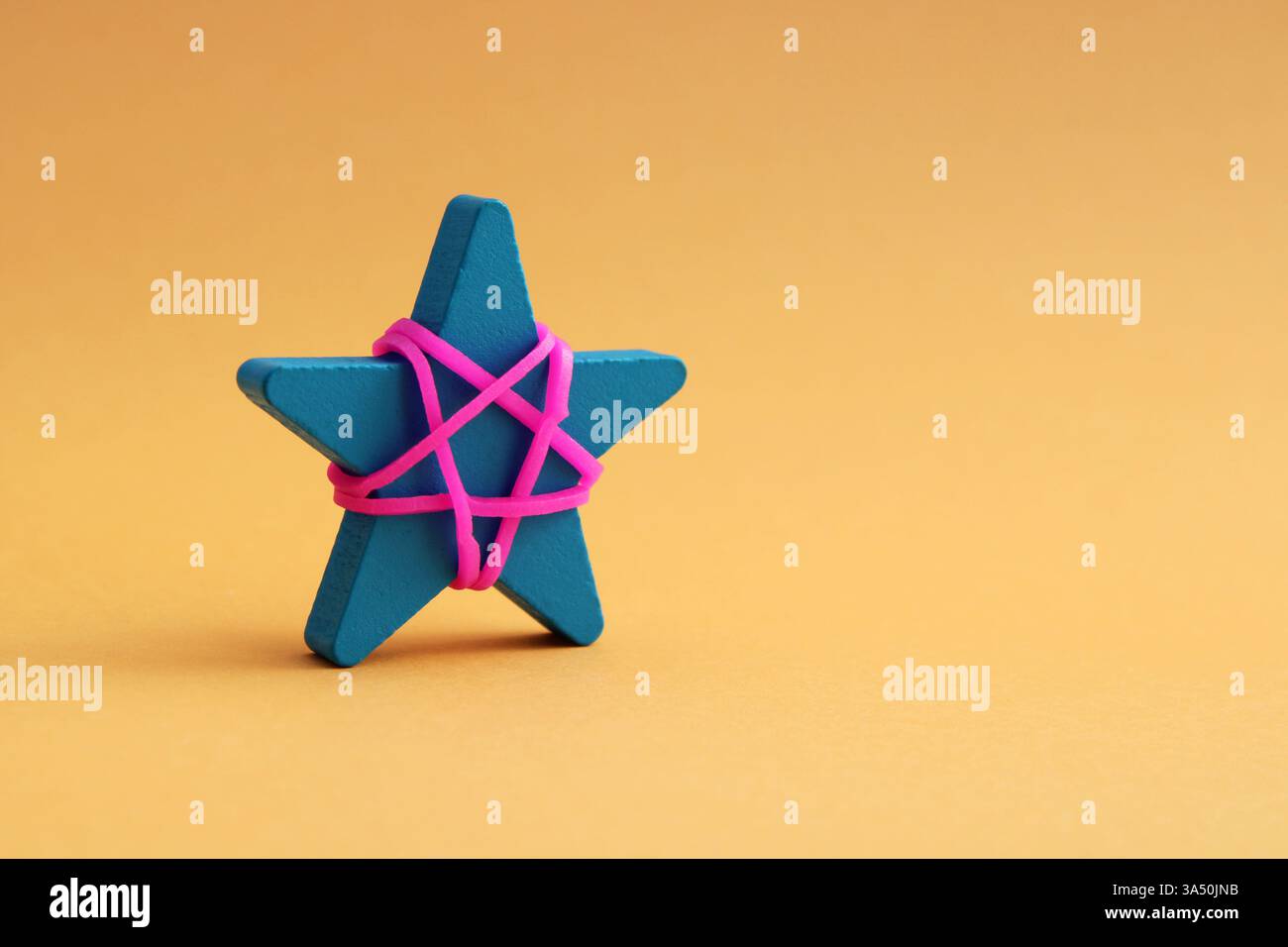 Wooden star with rubber bands forming another star Stock Photo - Alamy