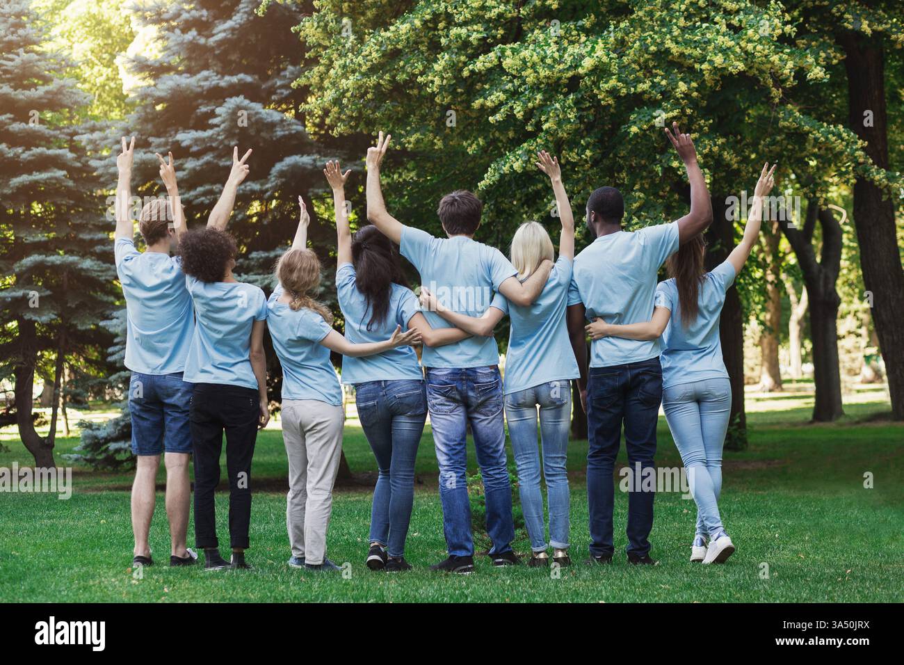 Volunteering, unity and charity. Group of volunteers embracing and ...