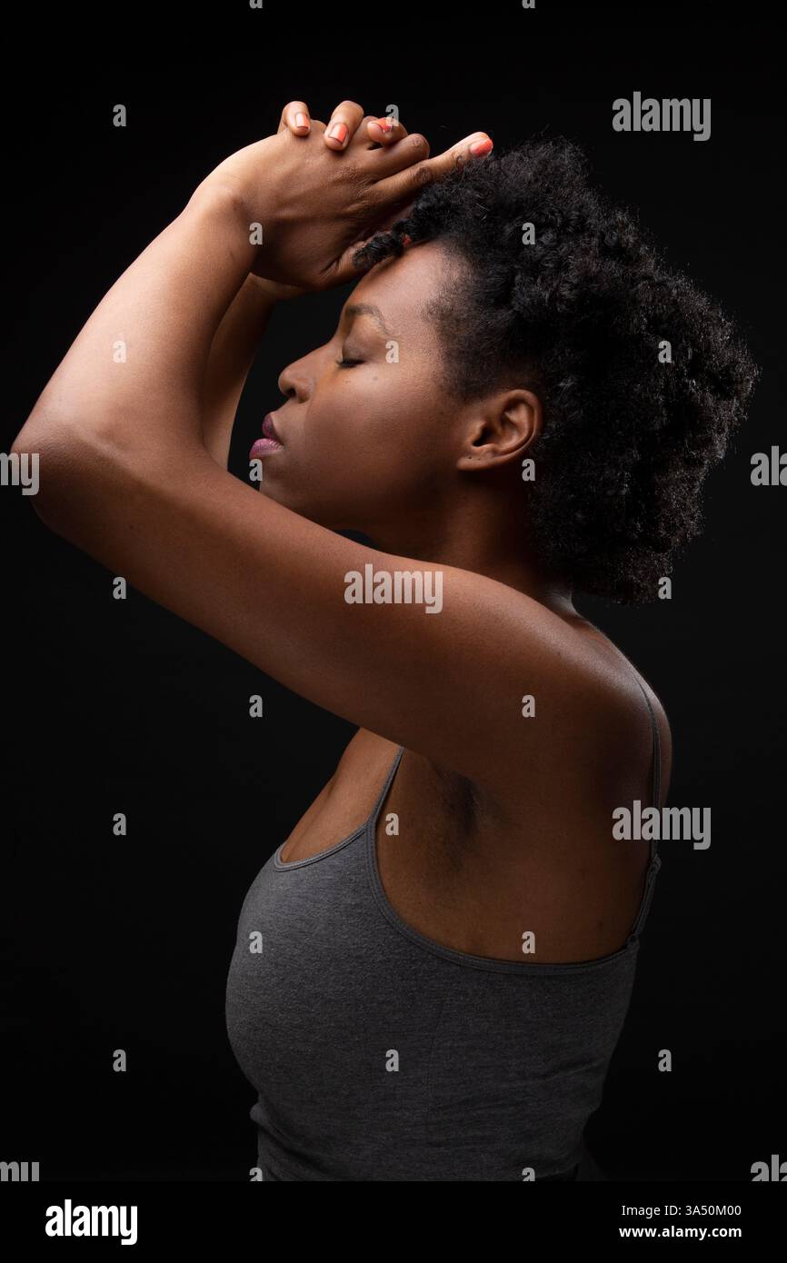 Serious Black woman deeply thinking praying meditating stressed ...