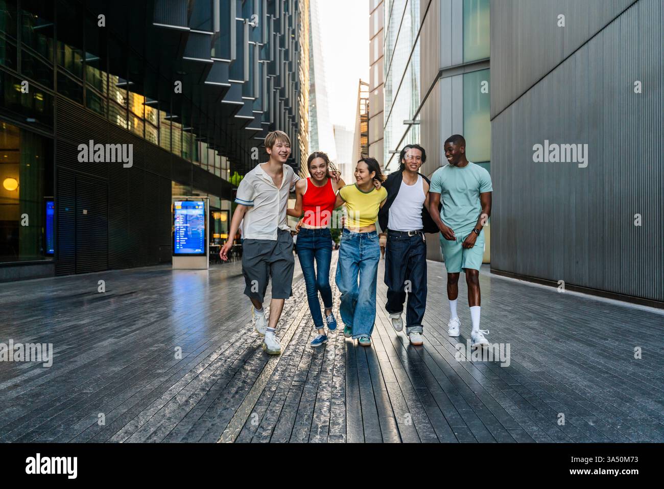 Multiracial group of smiling friends exploring London near Tower Bridge ...