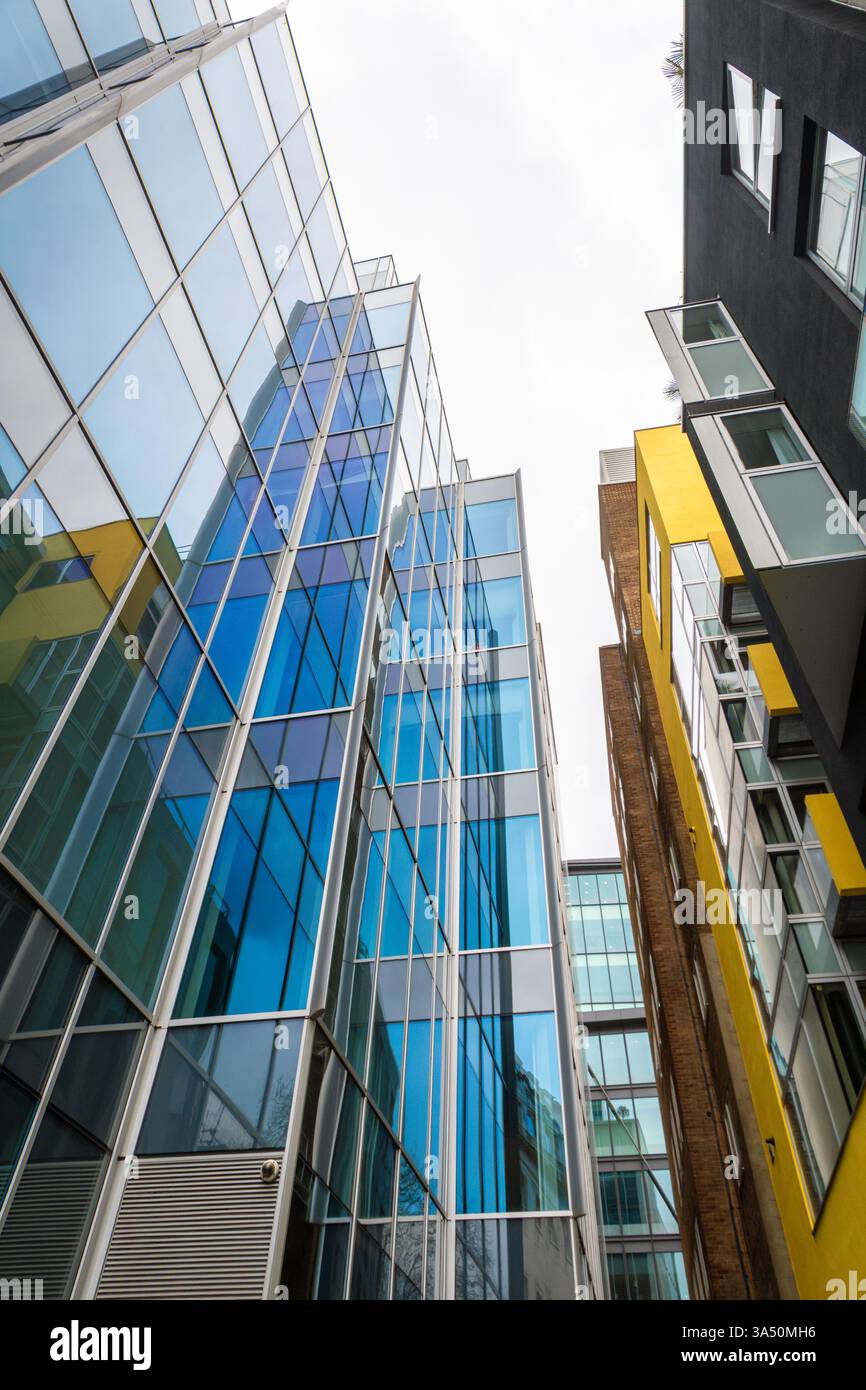 Looking up at colourful modern architecture, high rise buildings from ...