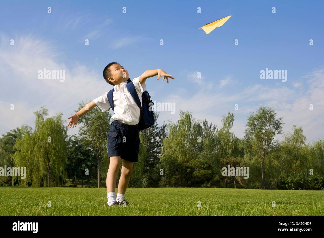 Chinese boy playing with a paper airplane Stock Photo - Alamy