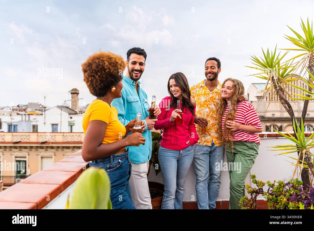 Cheerful diverse group of friends chatting and drinking beer having fun ...