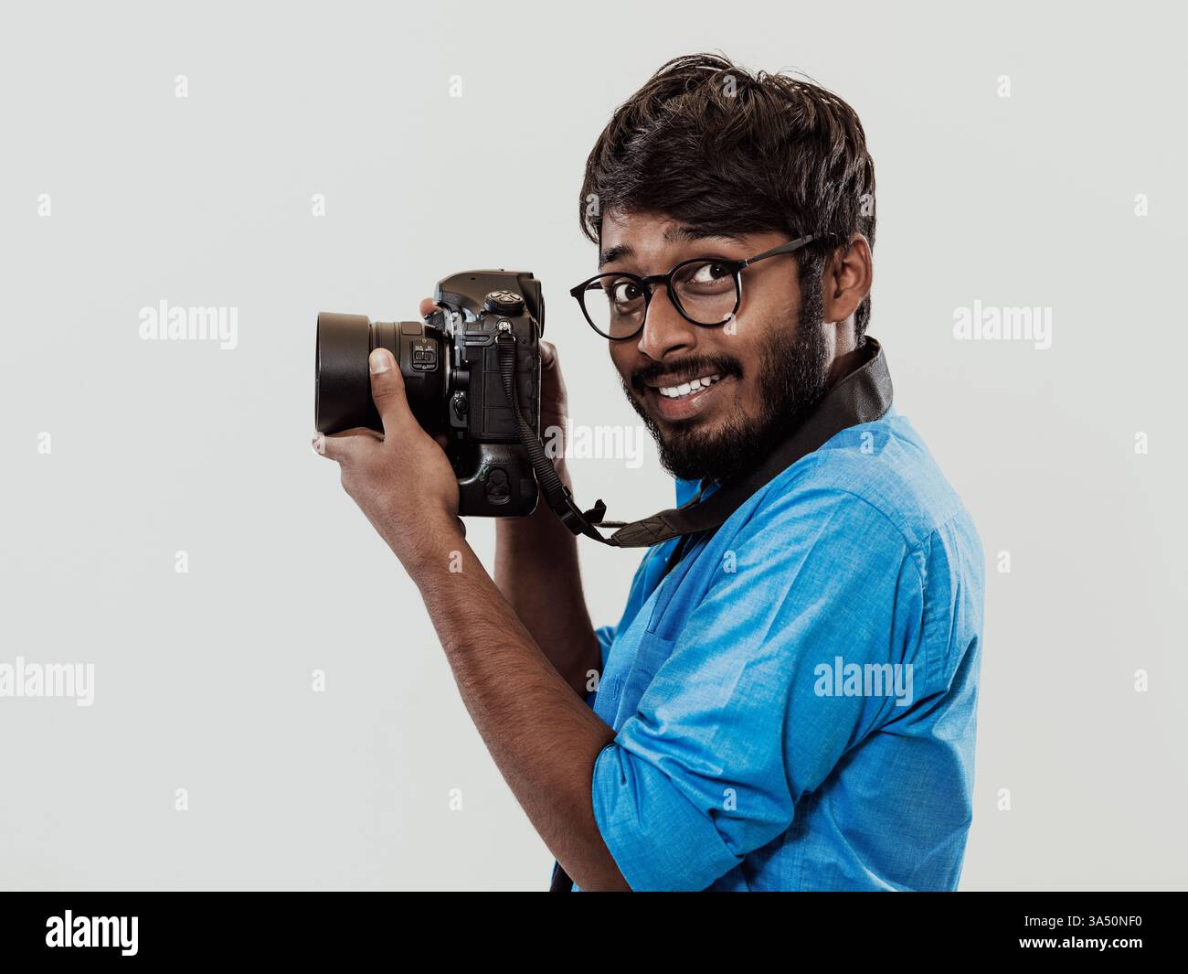 Professional photographer having DSLR camera taking picture.Indian man ...
