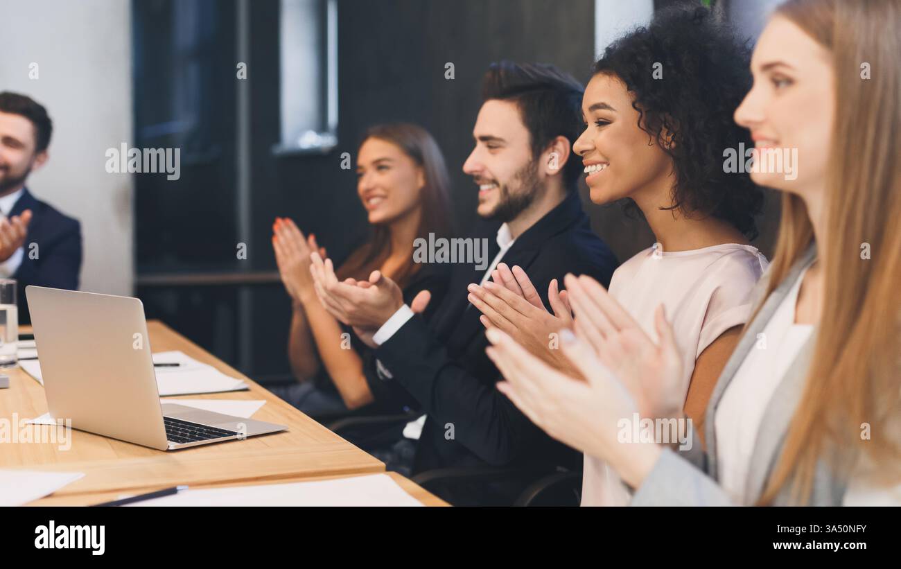 Successful young business group applauding after presentation and ...
