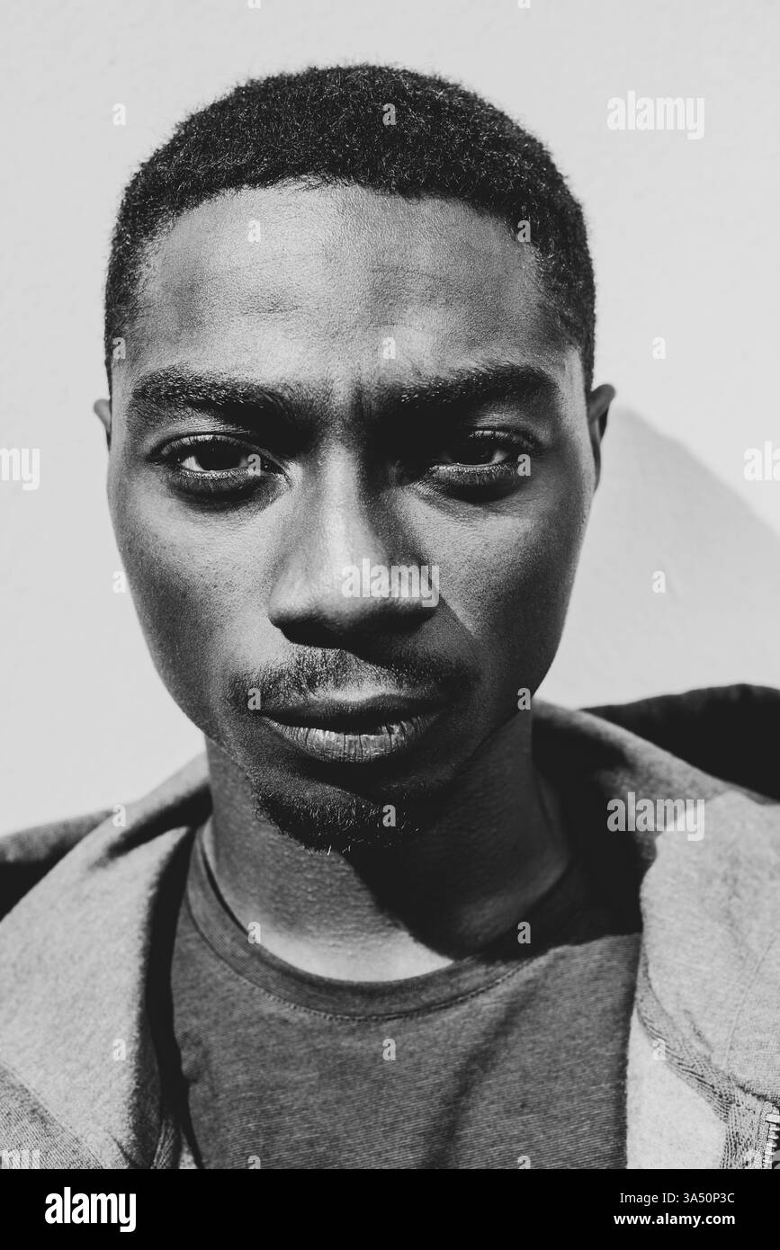 Close up black and white portrait serious young African American man ...
