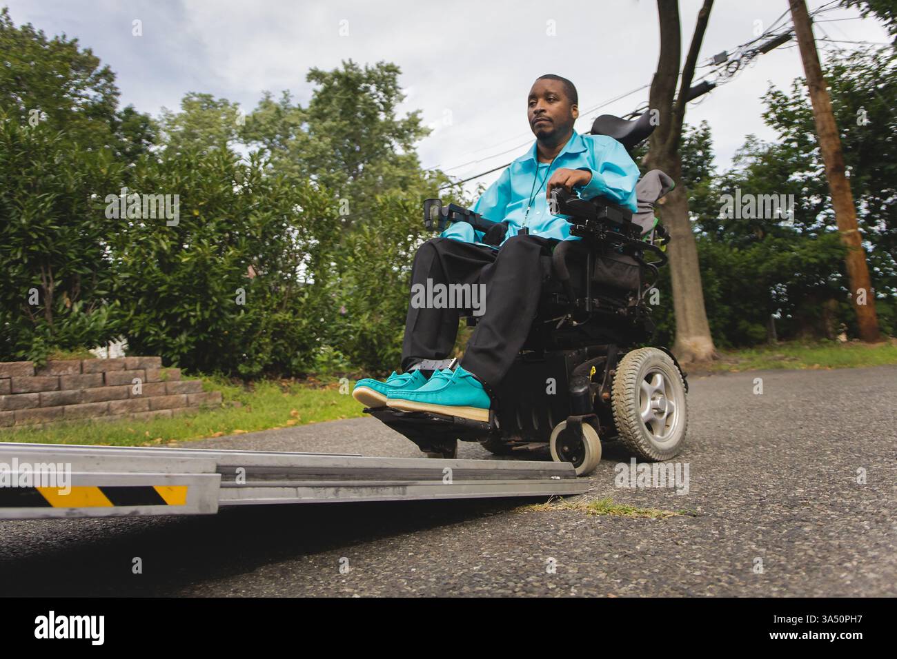 Disabled African American man sitting riding in his motorized ...