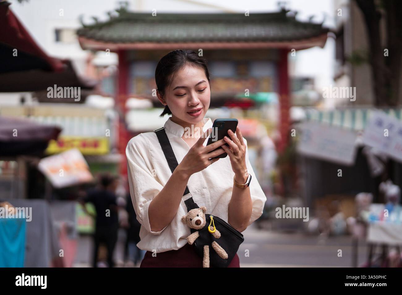Young Asian female traveler using mobile phone Stock Photo - Alamy