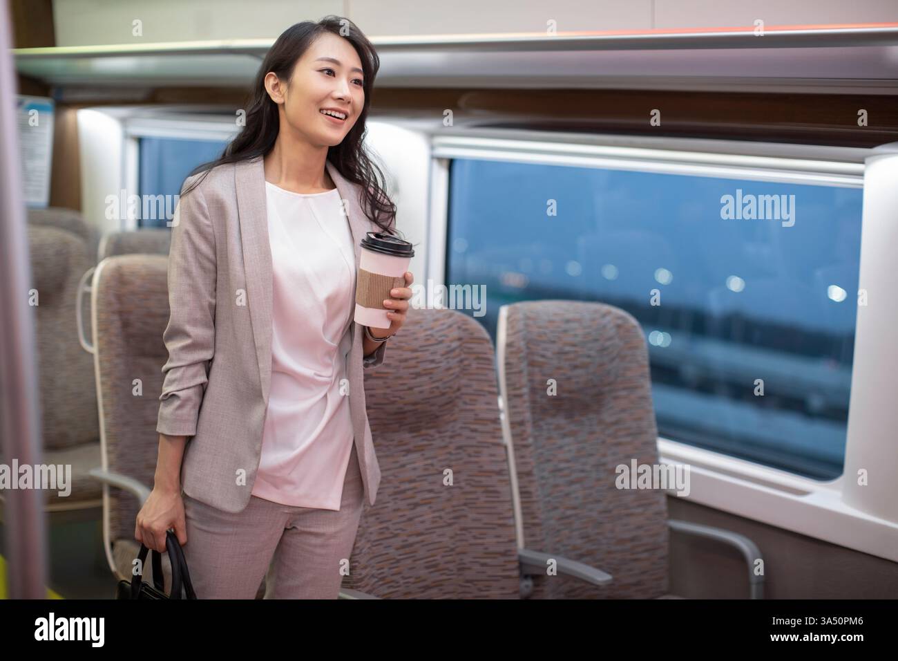 Chinese business woman holding disposable coffee cup standing inside ...