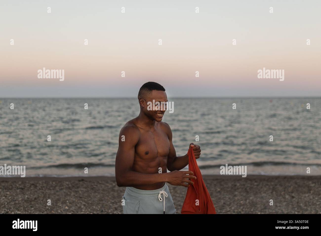 African man putting shirt on hi-res stock photography and images - Alamy