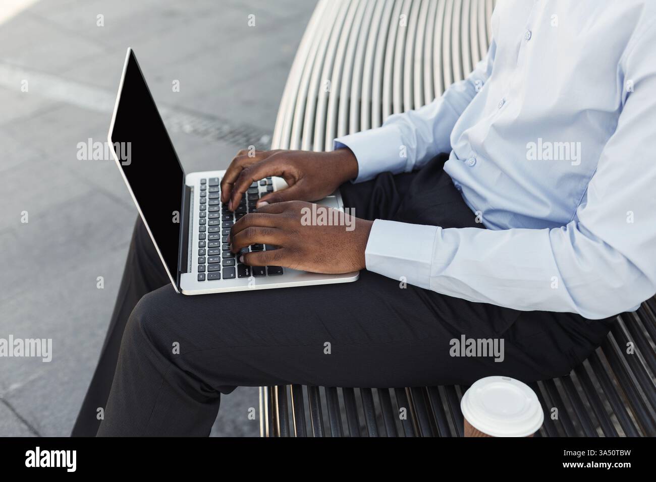 African-american male hands typing on laptop keyboard. Unrecognizable black businessman working ...