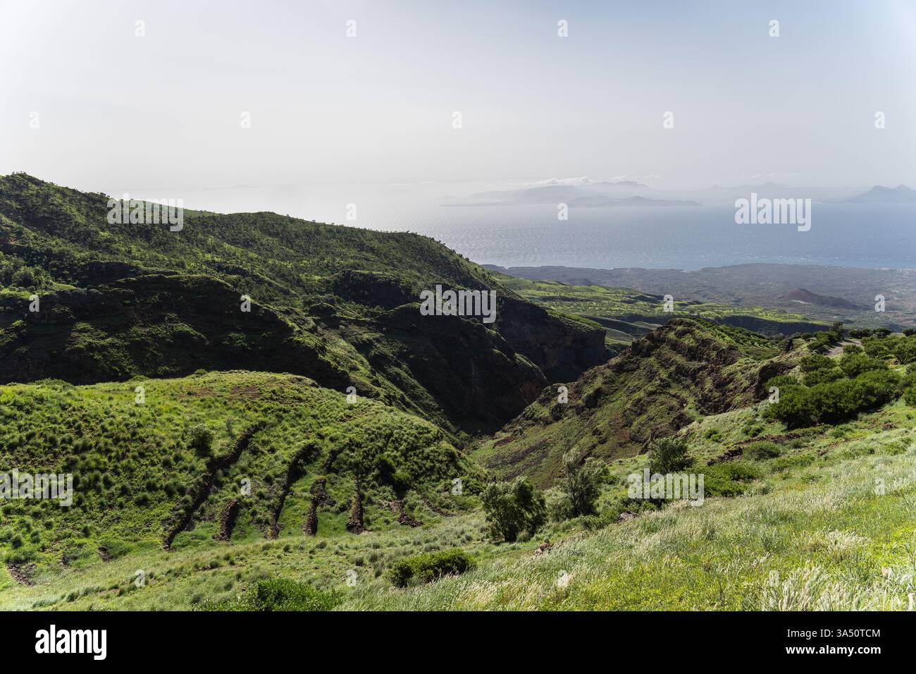 Volcanic hills and verdant valleys descend toward the Atlantic Ocean on ...