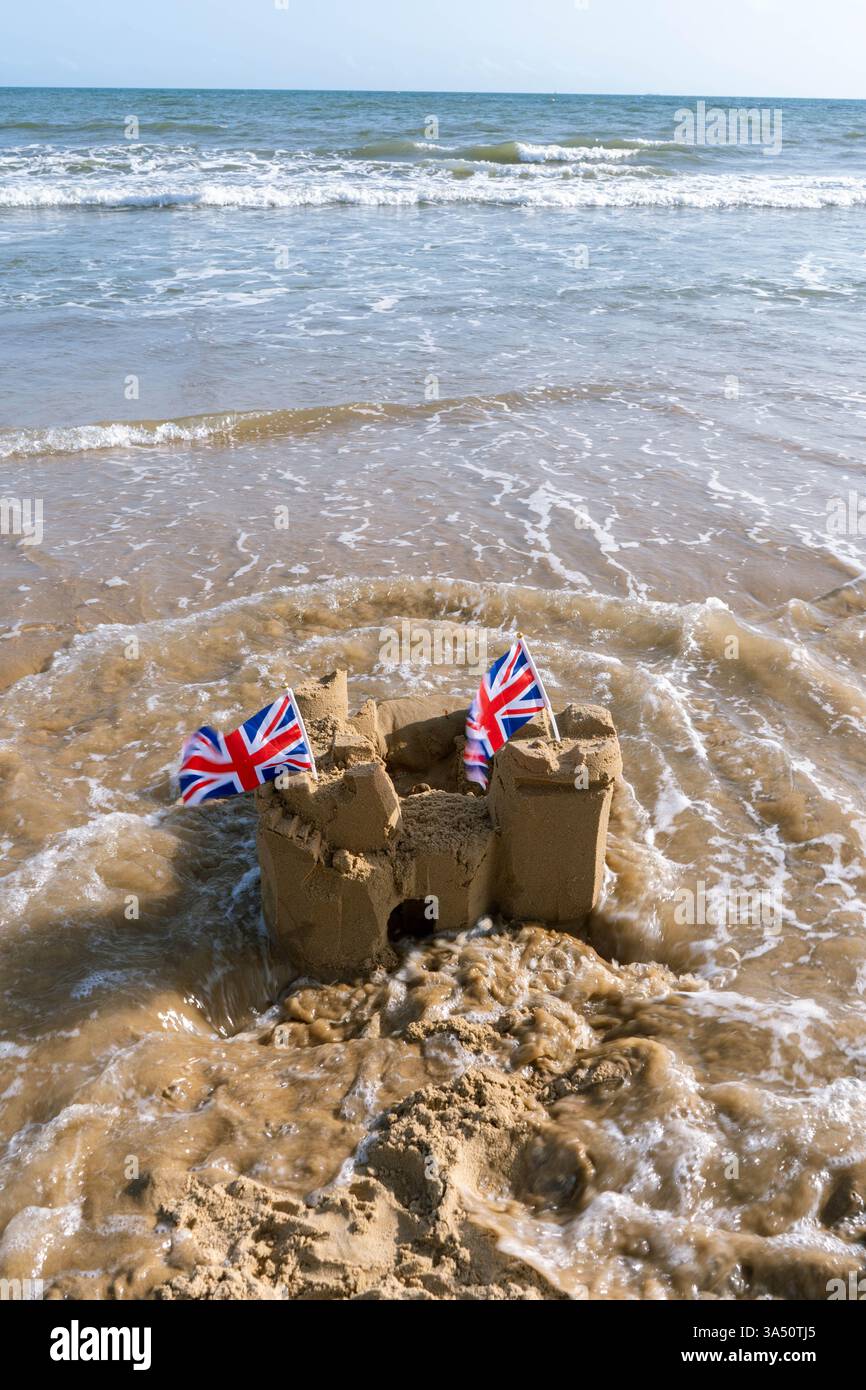 Sand castle with standing the waves Stock Photo - Alamy