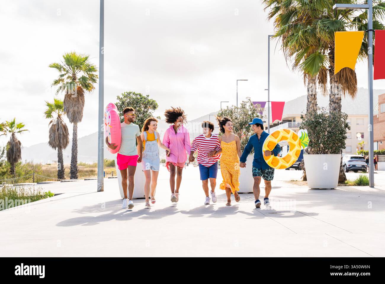 Multiethnic group of young happy friends bonding outside, having fun on ...