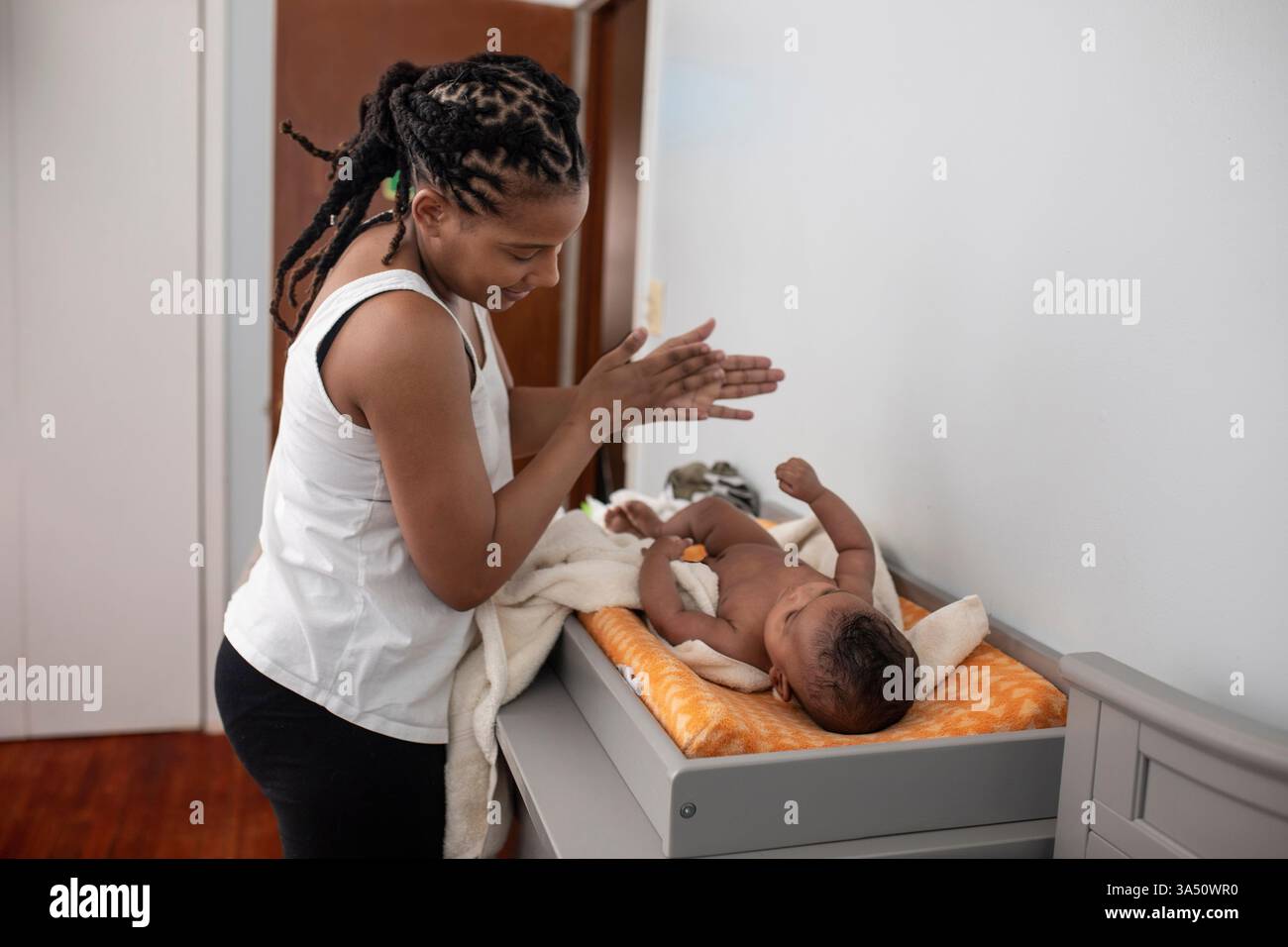 Changing baby clothes hi-res stock photography and images - Alamy
