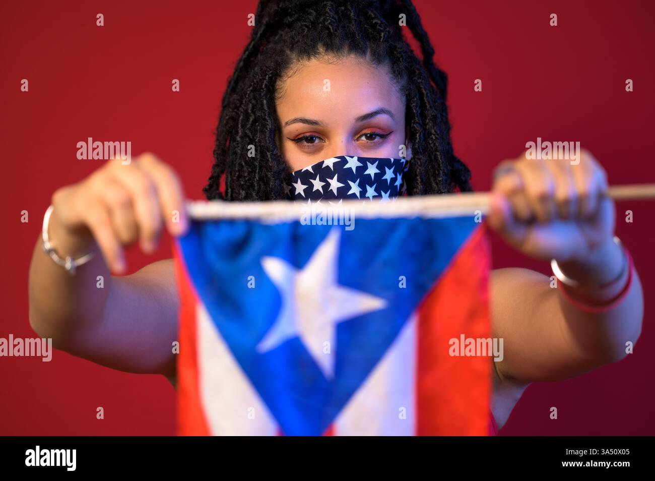 Afro-Latina woman holding Puerto Rican flag with two hands Stock Photo ...