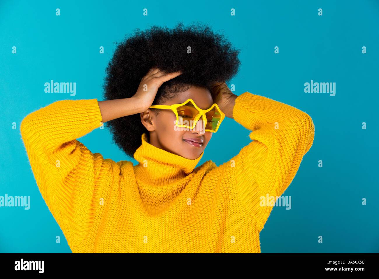 Black woman with closed eyes wearing star shaped sunglasses touching ...