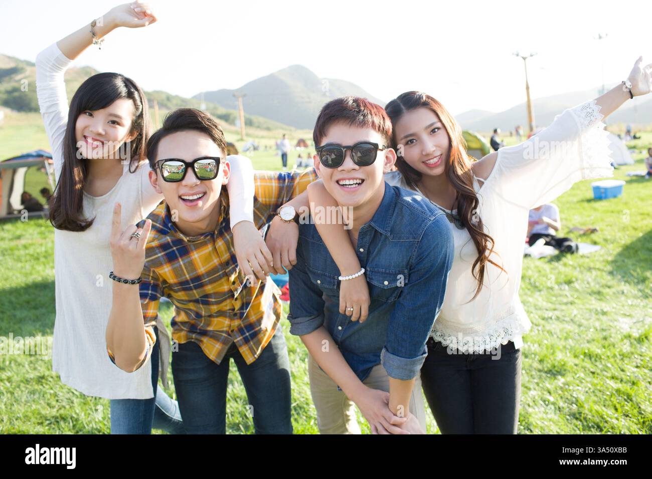 Happy Chinese friends at music festival Stock Photo - Alamy