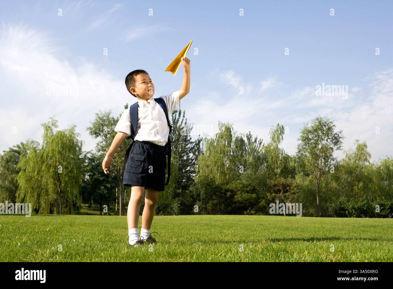 Chinese boy playing with a paper airplane Stock Photo - Alamy