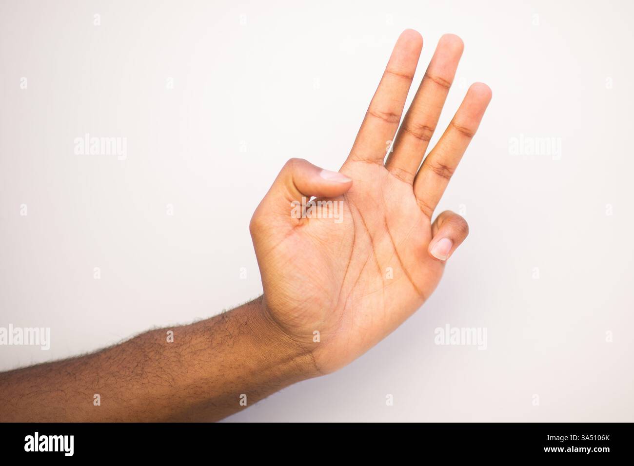 Black male doing number three hand sign against white background Stock ...