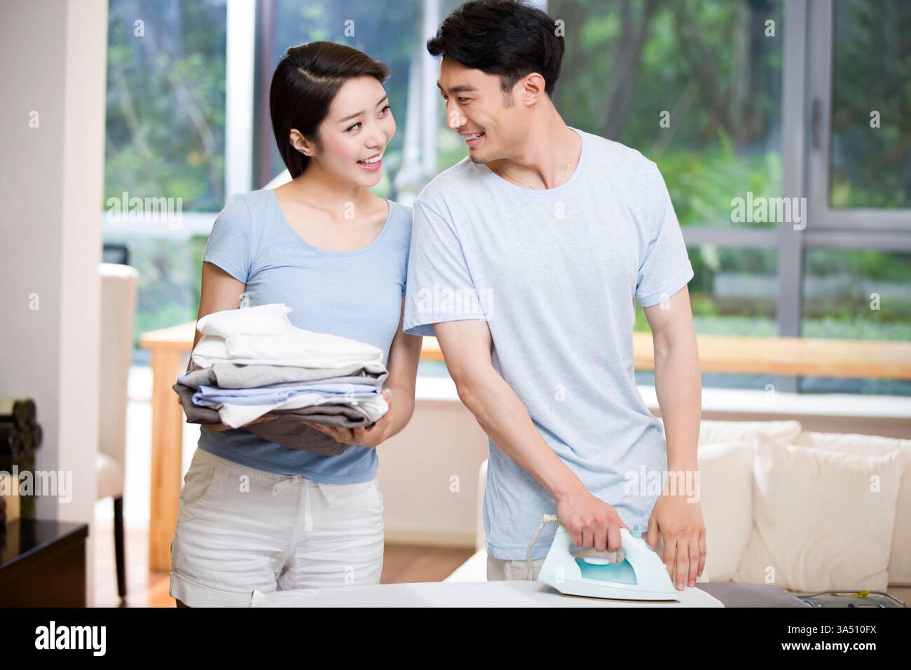 Young Chinese couple doing housework Stock Photo - Alamy