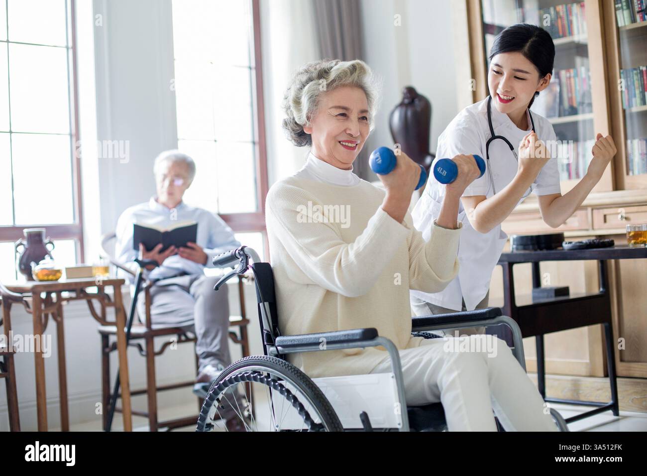 Senior Chinese woman exercising with dumbbell in Chinese nursing home ...