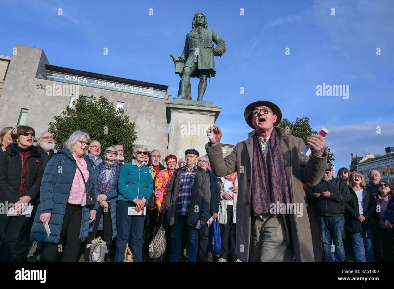 20 March 2025, Saxony-Anhalt, Halle (Saale): Members of a mixed choir ...