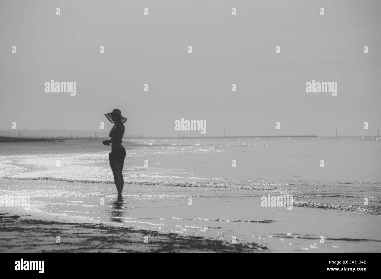 Young woman pose in fashionable clothes on the sand beach. Beautiful ...