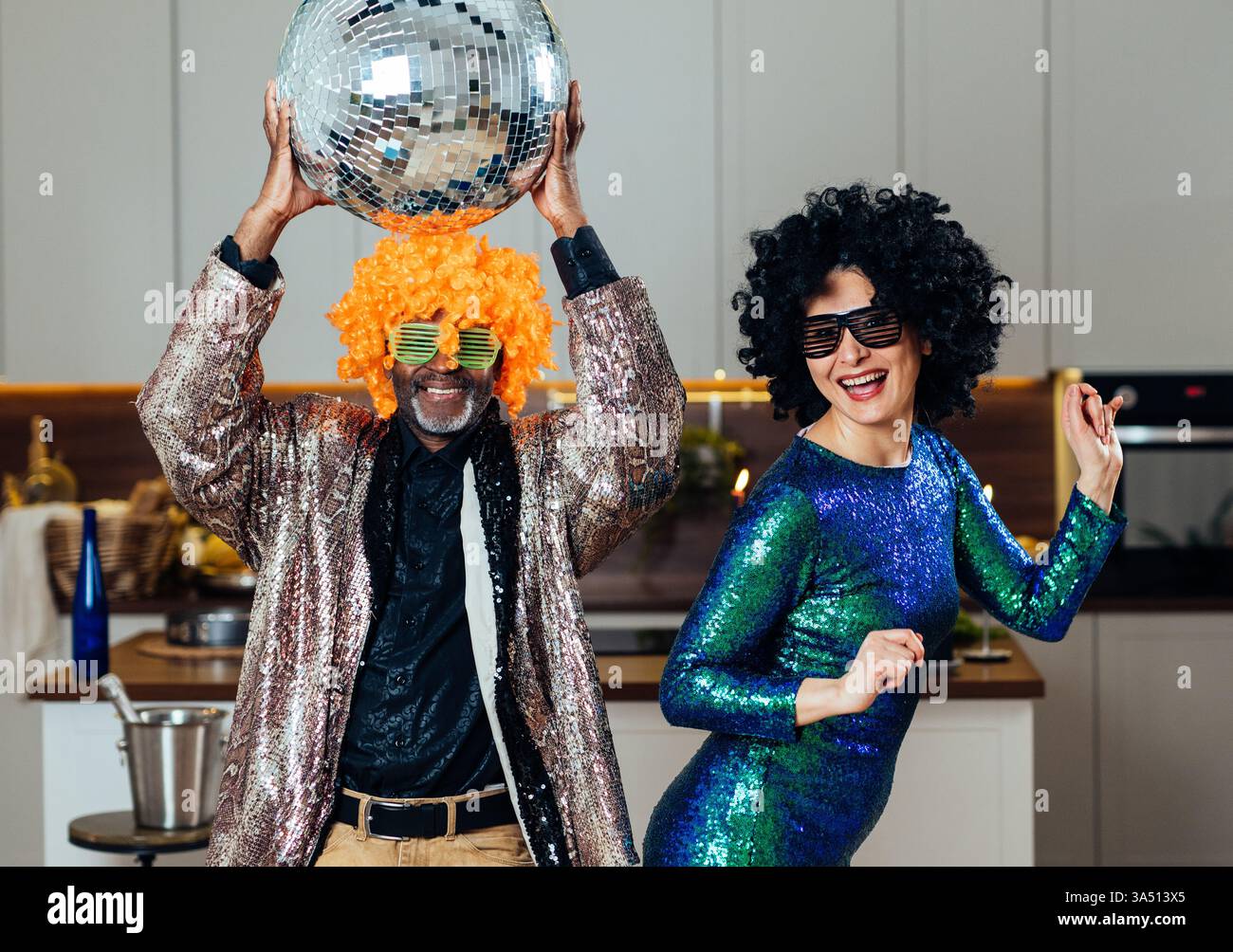 Cinematic image of an happy multiethnic senior couple making party ...