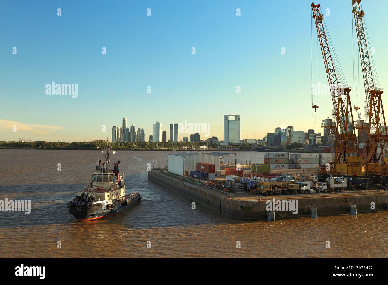 Tug boat cruising around a container wharf at the Port of Buenos Aires ...