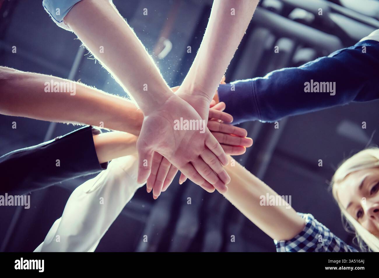Diverse group of business people putting their hands together ...