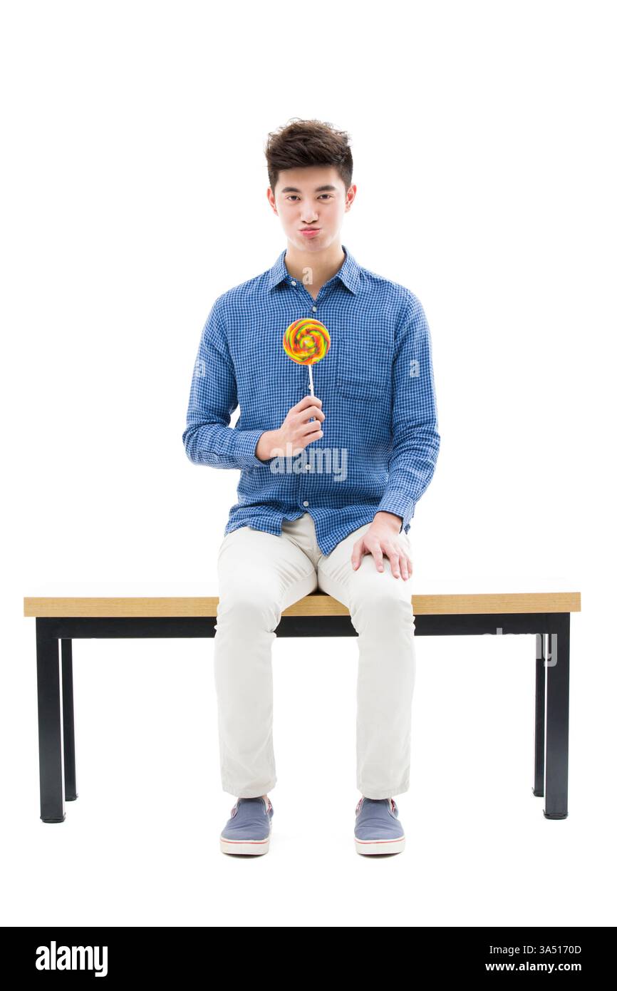 Young Chinese man holding a lollipop Stock Photo - Alamy