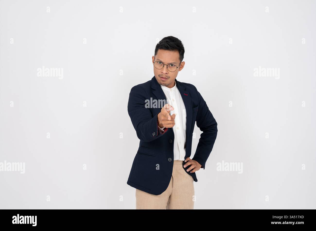 A dissatisfied, angry, and furious Asian businessman is pointing his ...