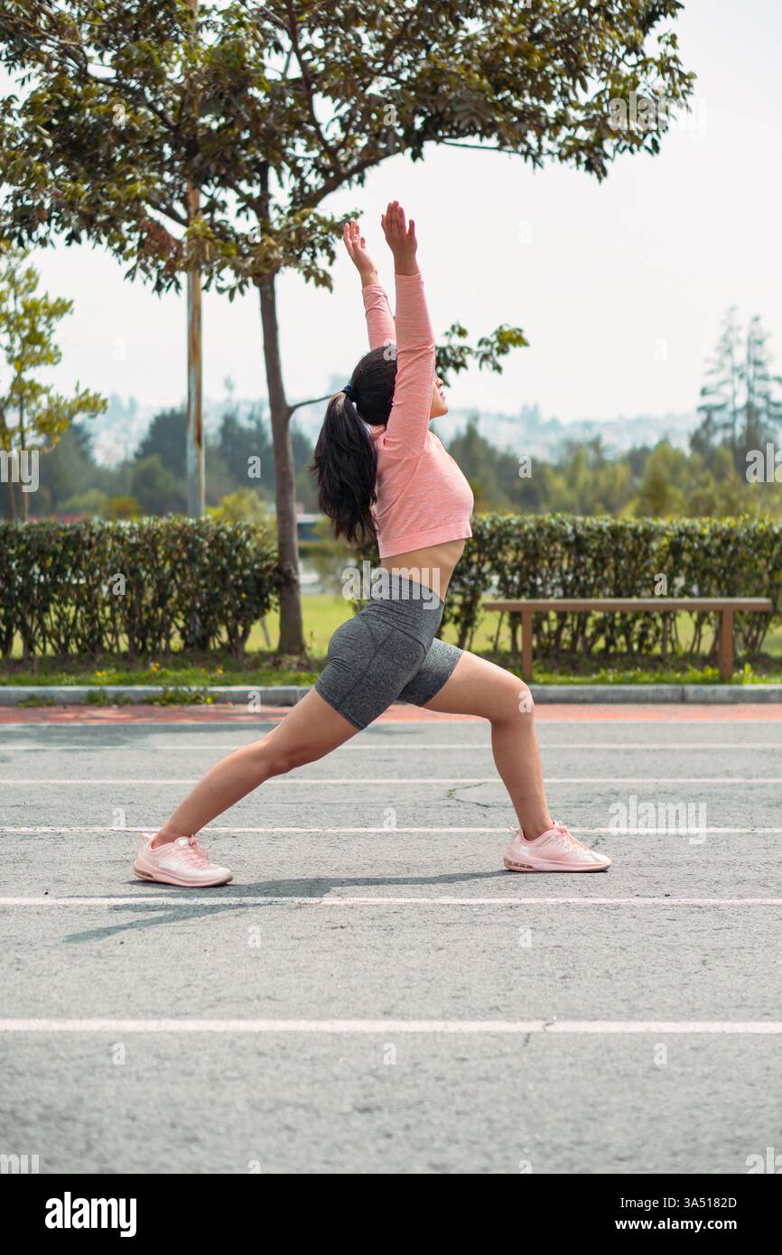 Side view full body of young female athlete in activewear with ponytail ...