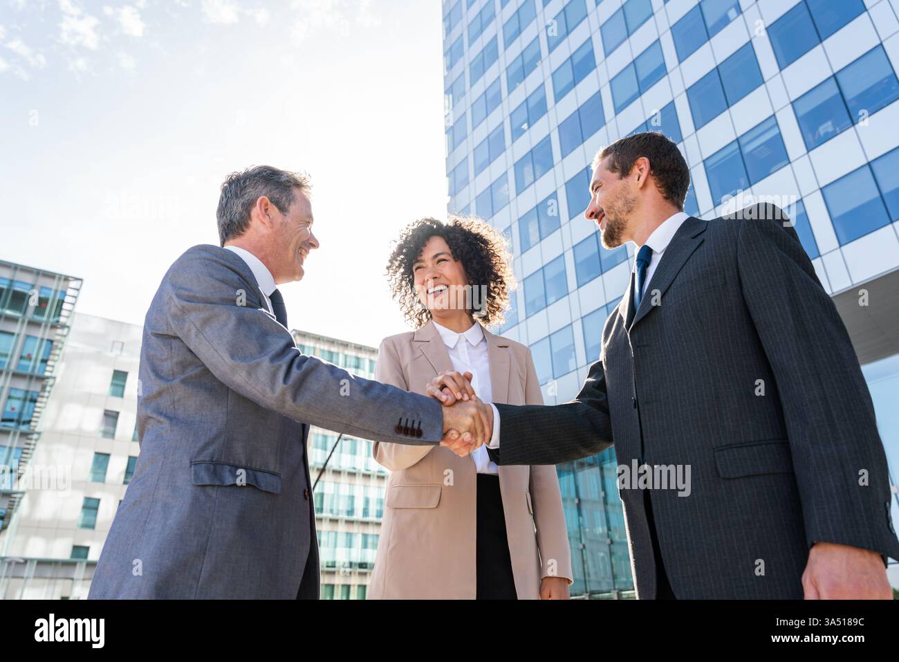 Group of diverse professionals in a city setting showing teamwork by ...