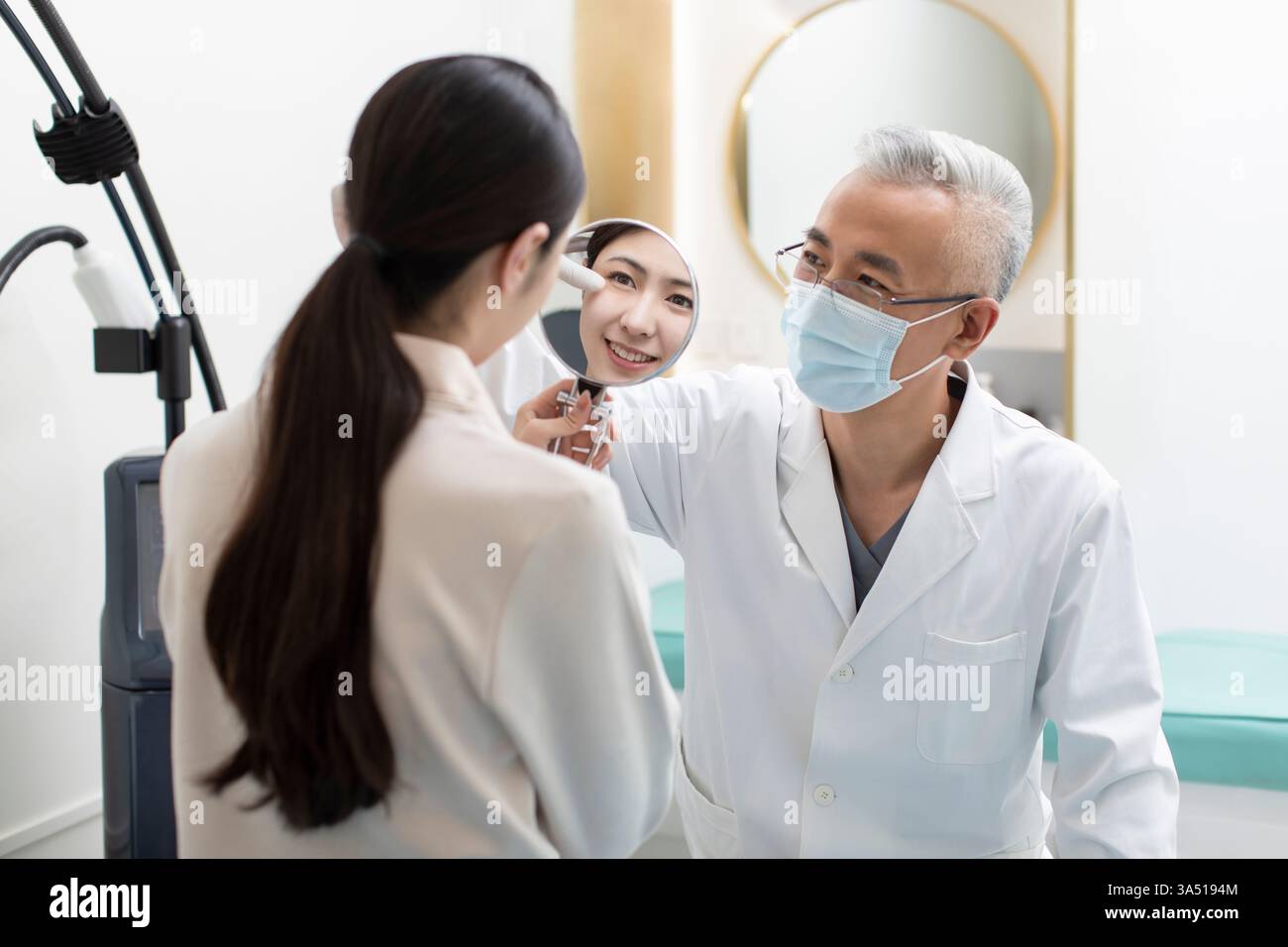 Chinese woman receiving face treatment to Chinese male doctor while ...