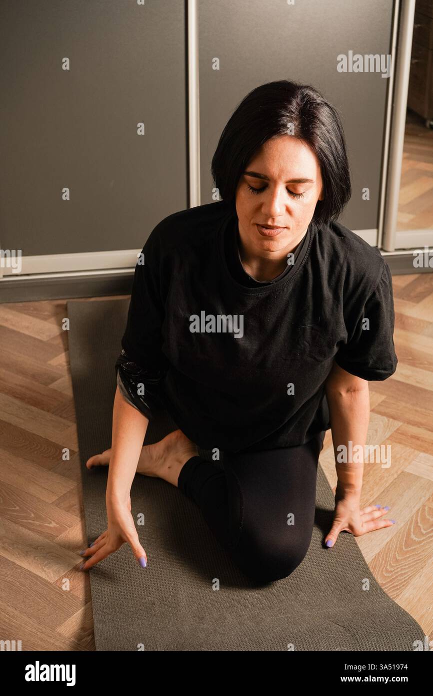 Her sleek sportswear and relaxed posture emphasize relaxation. A ...