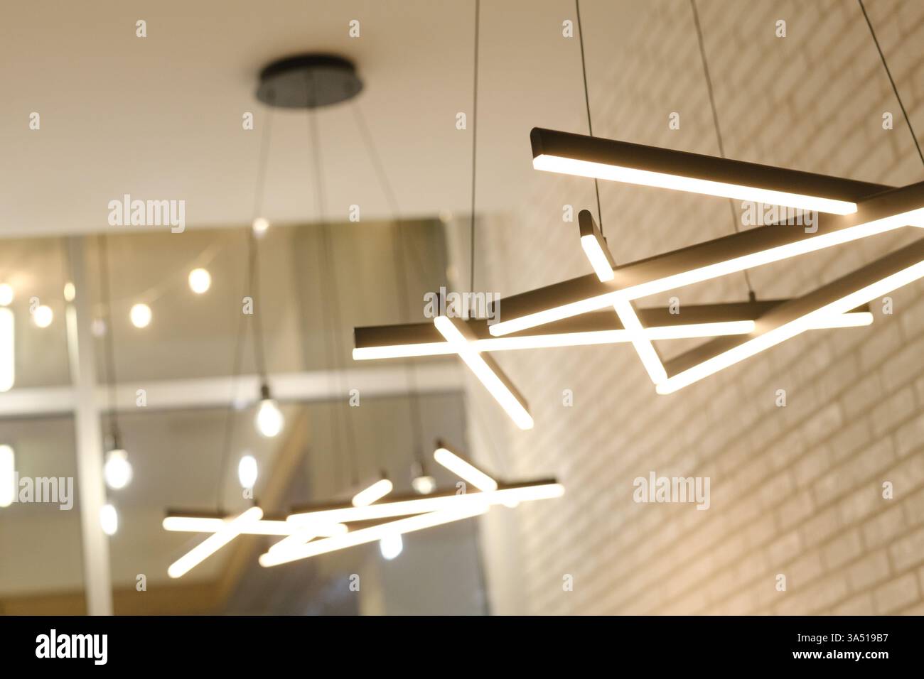 Stylish light fixtures hang from the ceiling, showcasing a creative ...