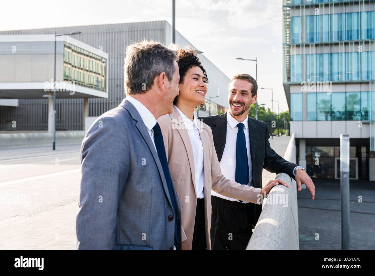 Group of business people standing together on bridge near building in ...