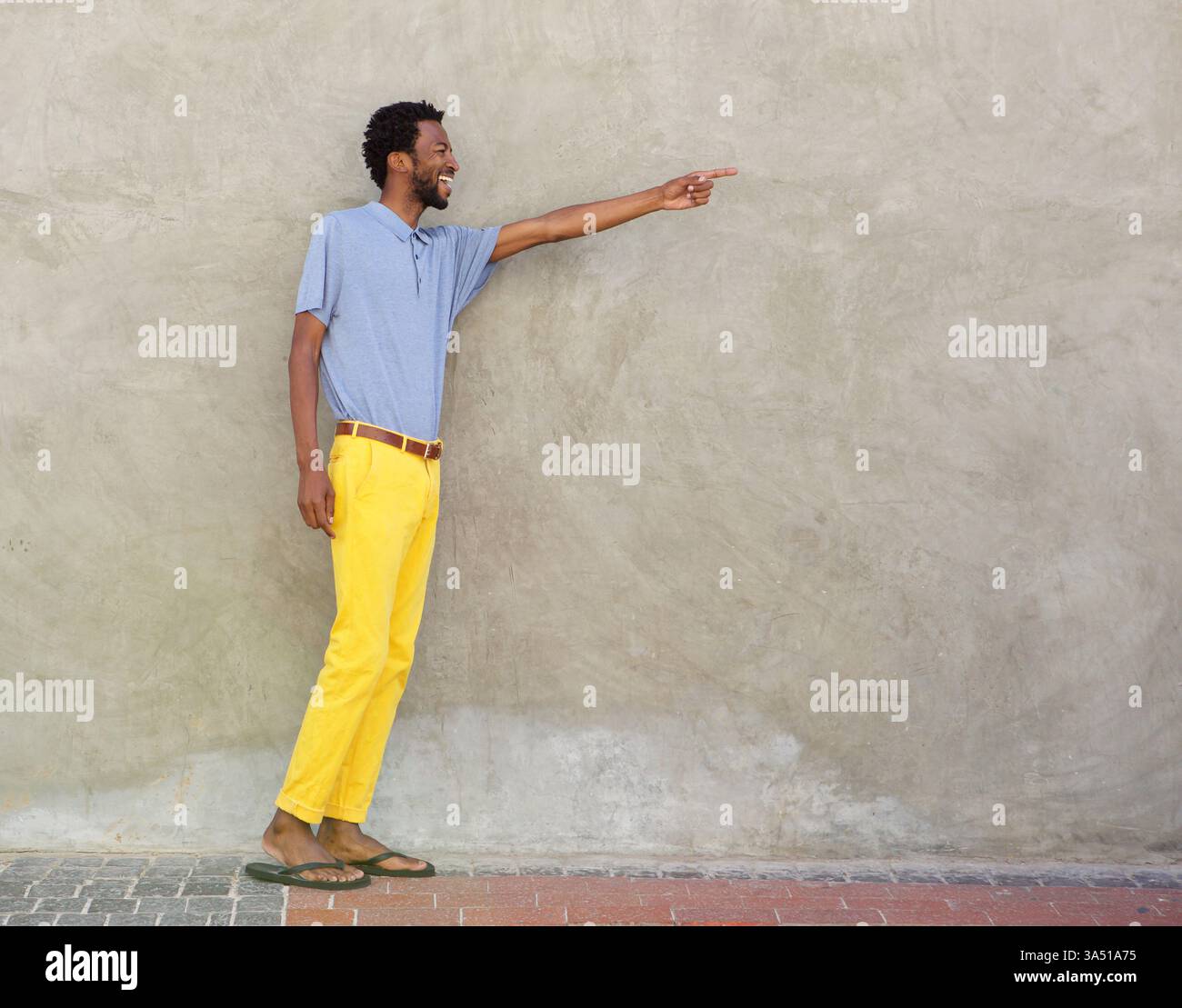 Full body side portrait of handsome african man pointing and smiling ...