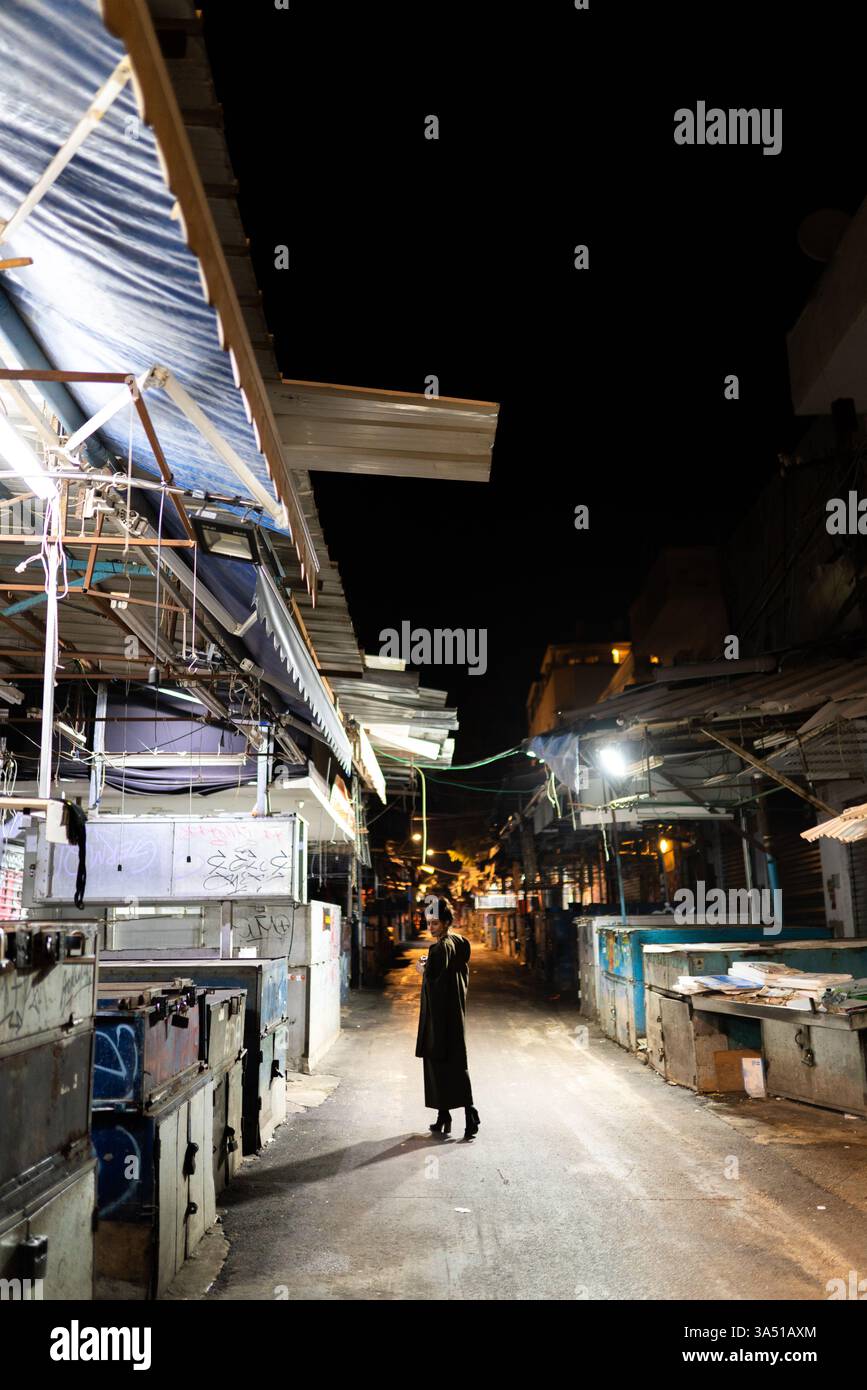 Middle Eastern woman looking over her shoulder on a Tel Aviv street ...