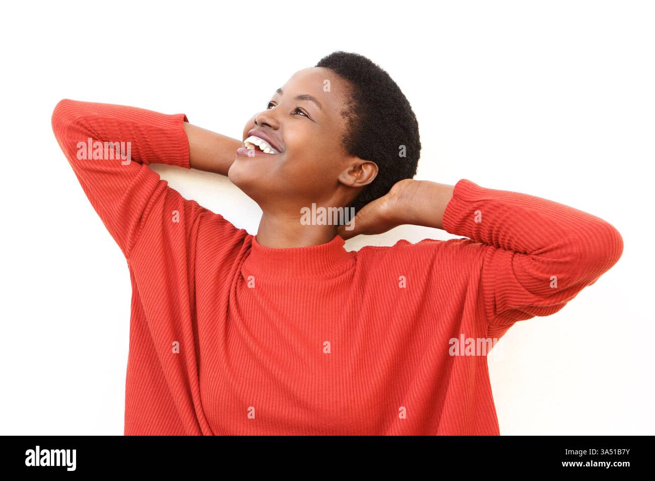 Cheerful African American woman hands on nape while standing against ...