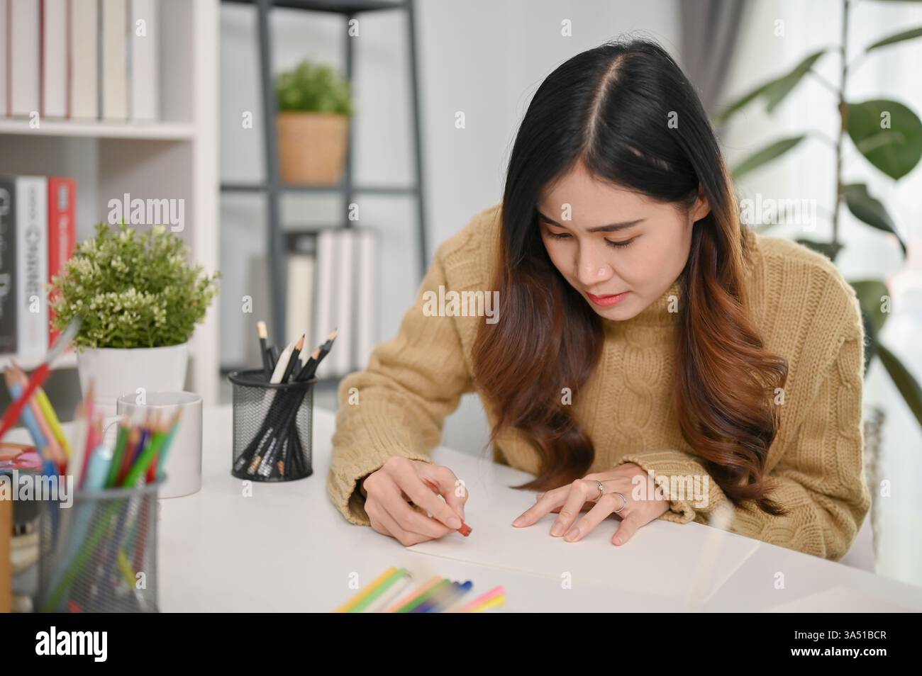 Beautiful concentrated young woman coloring hi-res stock photography ...
