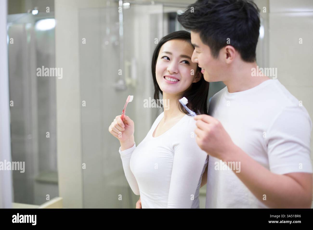 Happy young Chinese couple brushing teeth Stock Photo - Alamy