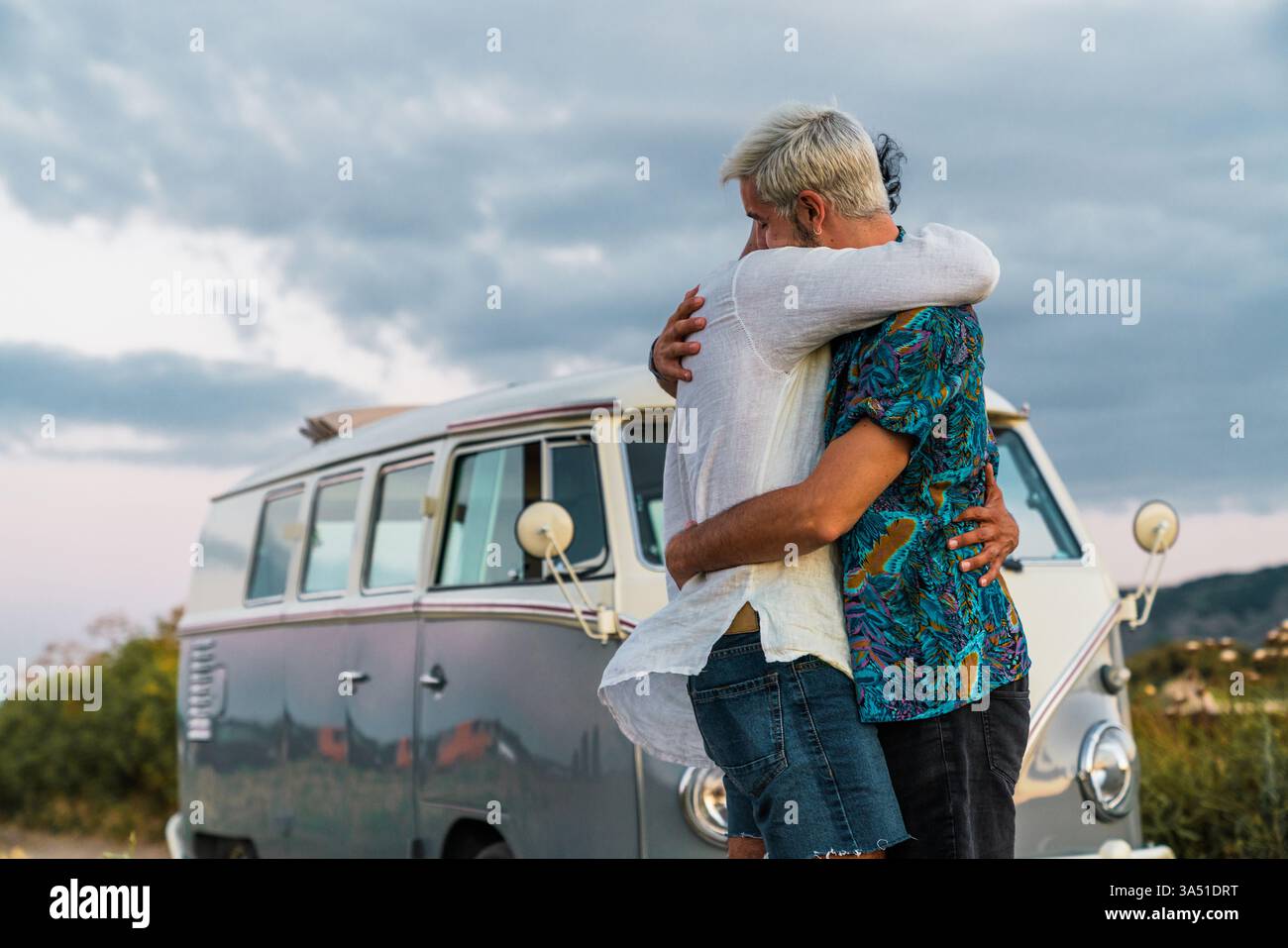Happy gay couple hugging side view men hi-res stock photography and ...