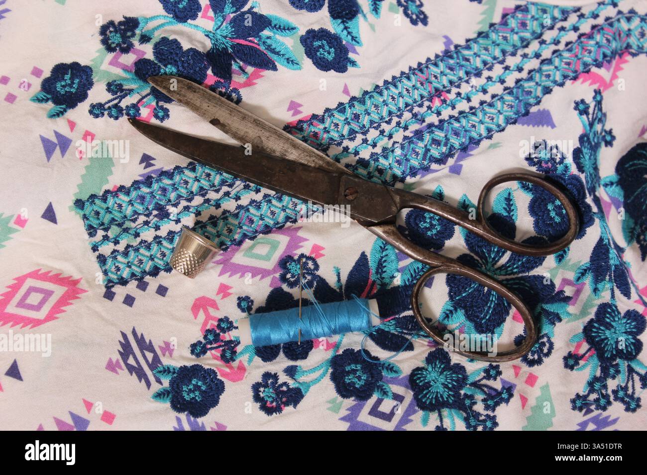 Vintage Embroidered Fabric With Spool of Blue Thread and Thimble Stock ...